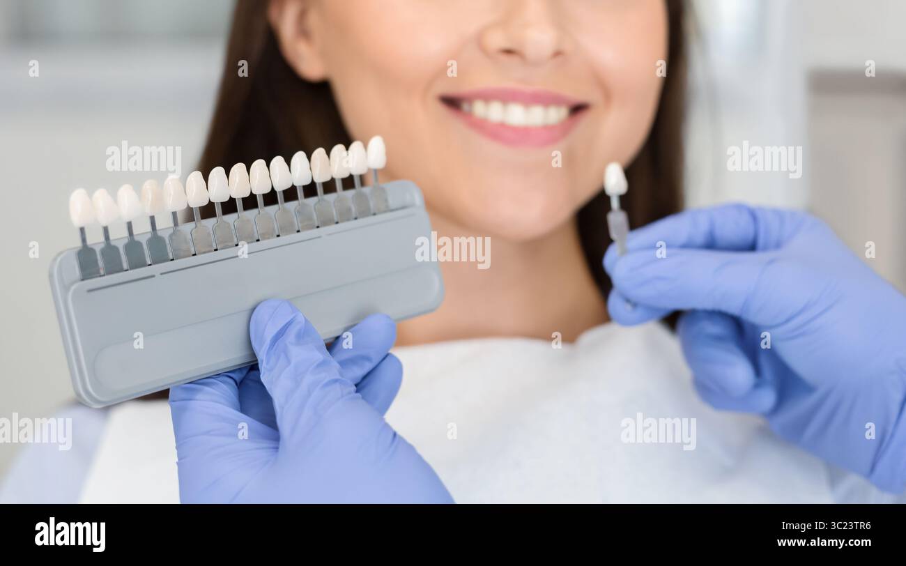 Doctor applying sample from tooth scale to smiling patient teeth Stock ...