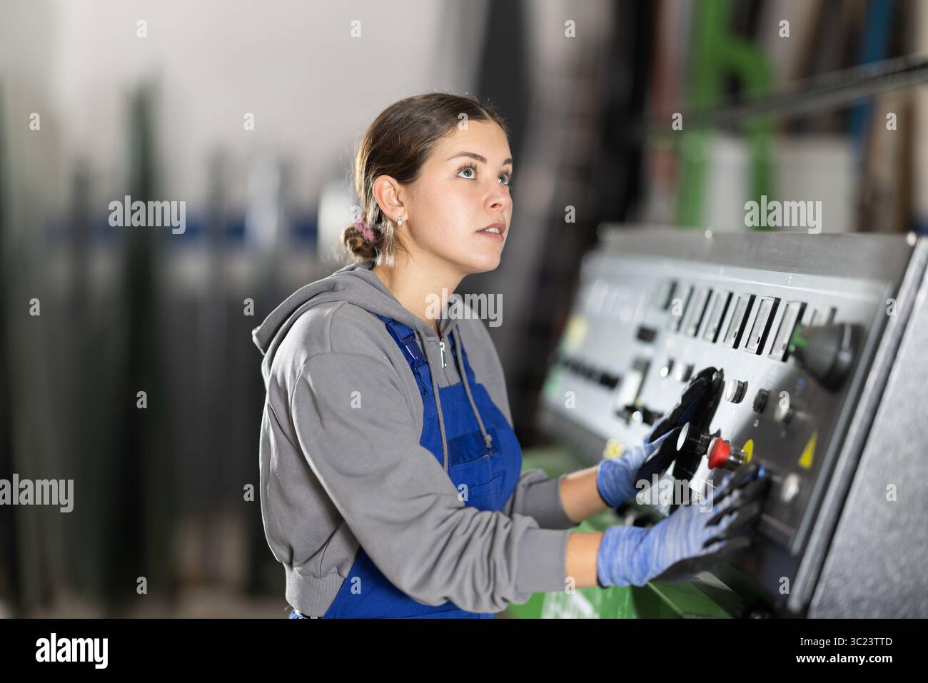 Young woman operates control panel in factory Stock Photo - Alamy