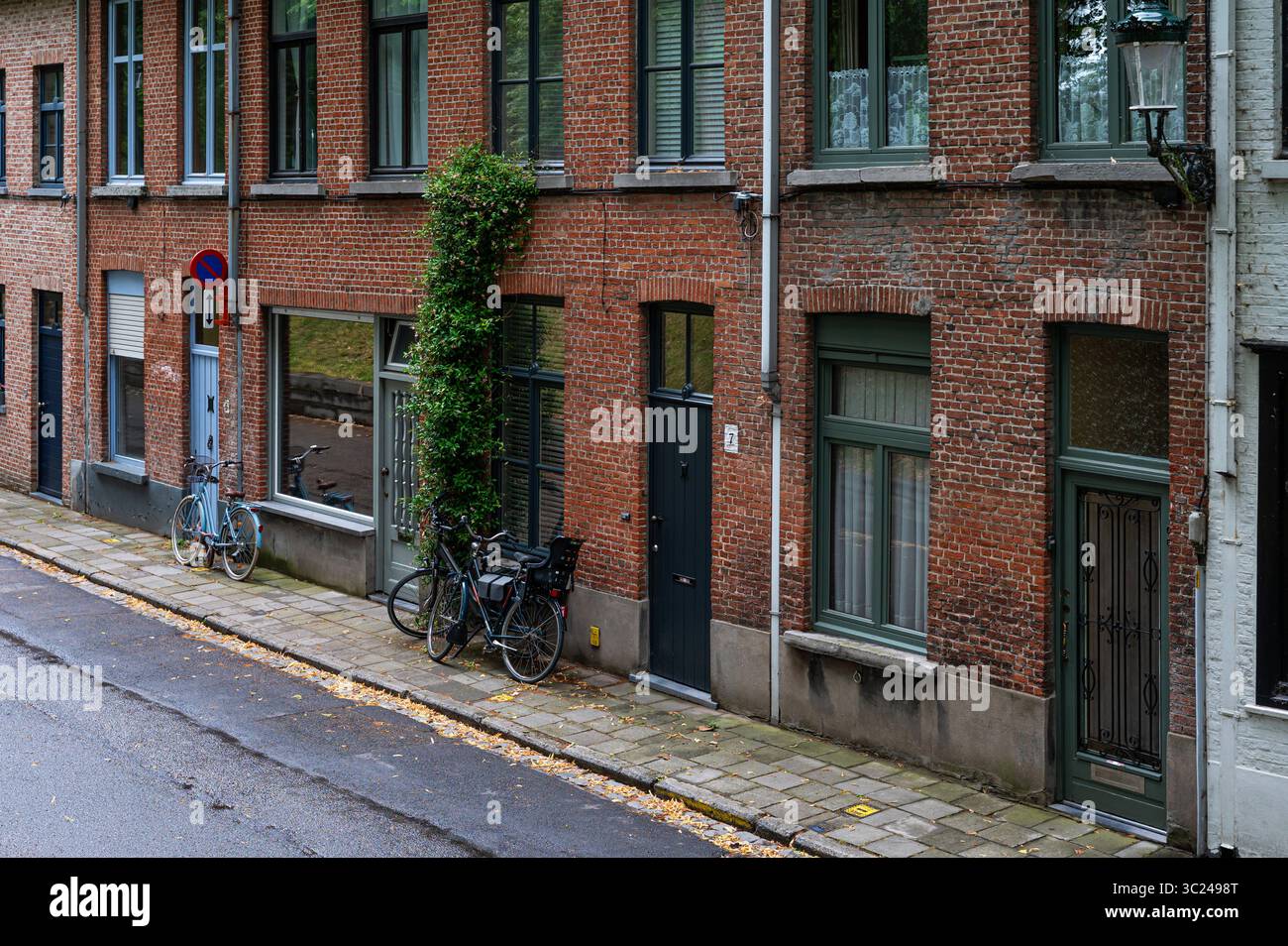 Modest historical houses in a row in the city center of Bruges, West ...