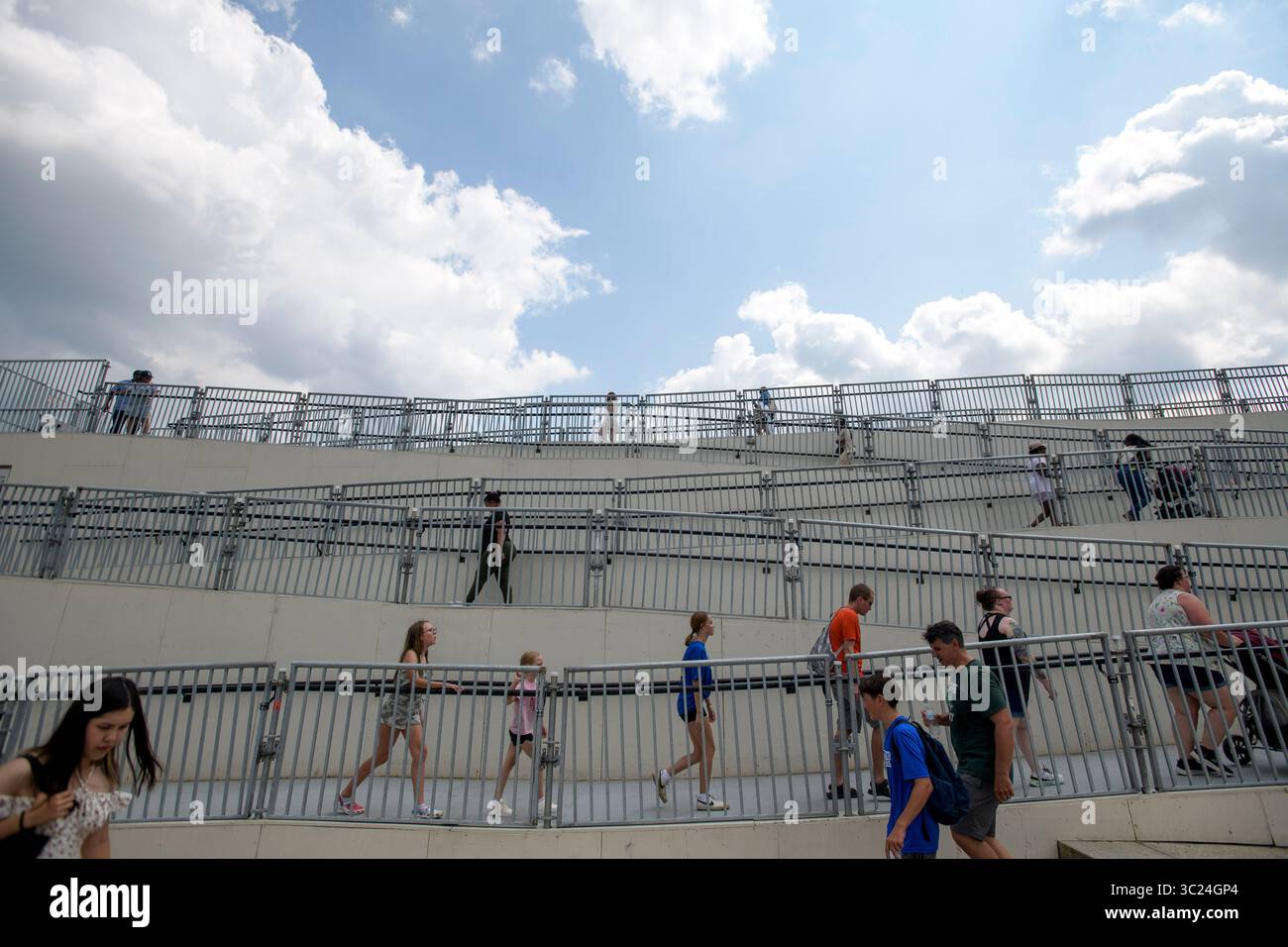 As the temperature reaches the low 90's, people make their way along ...