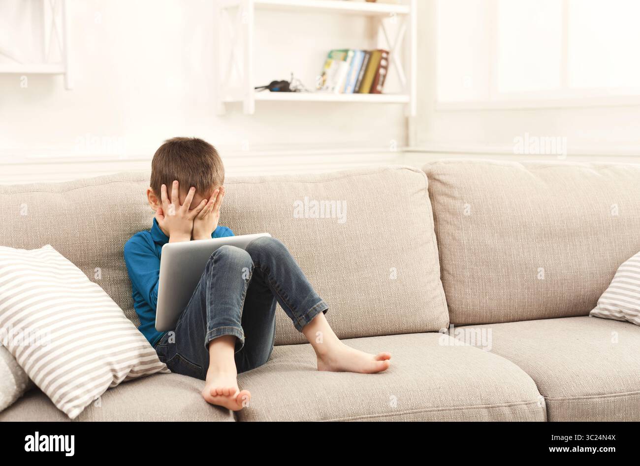 Sad teenager boy tablet hi-res stock photography and images - Alamy