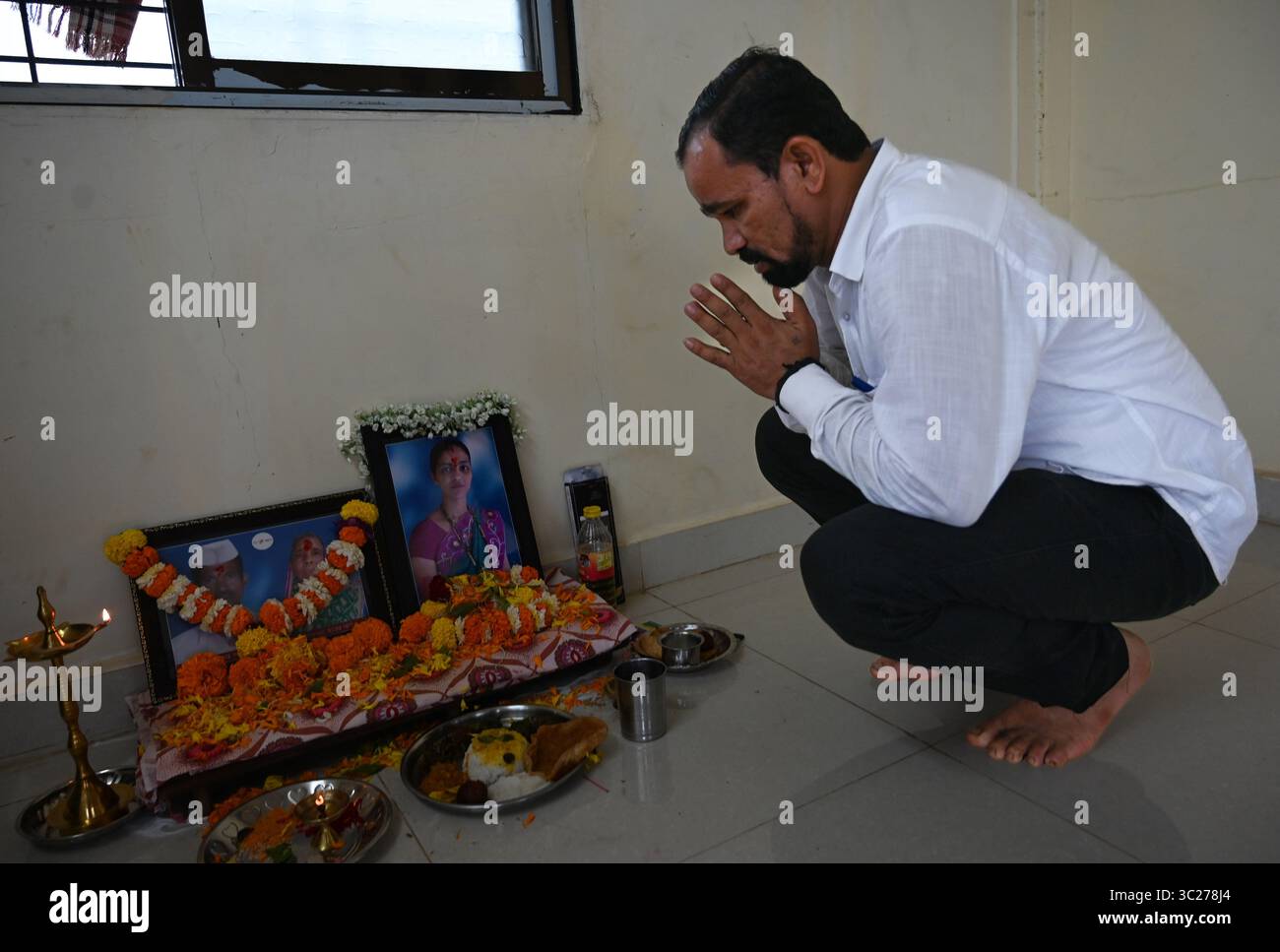 RAIGAD, INDIA - JULY 22: Vijay Pande pays tribute to his family members ...