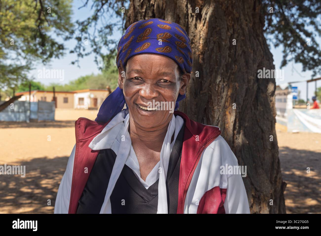 portrait of single african smiling woman in the village, poverty in the ...