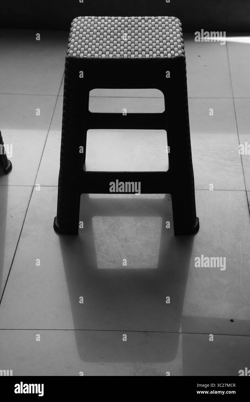 Simple white plastic chair hi-res stock photography and images - Alamy