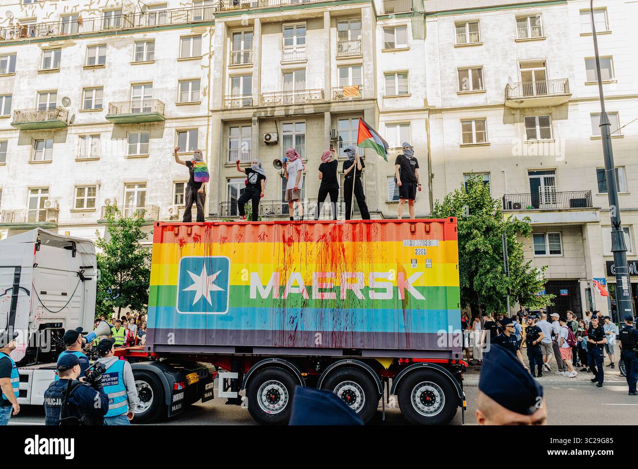 Protesters on top of the Maersk vehicle chant anti-genocide slogans ...