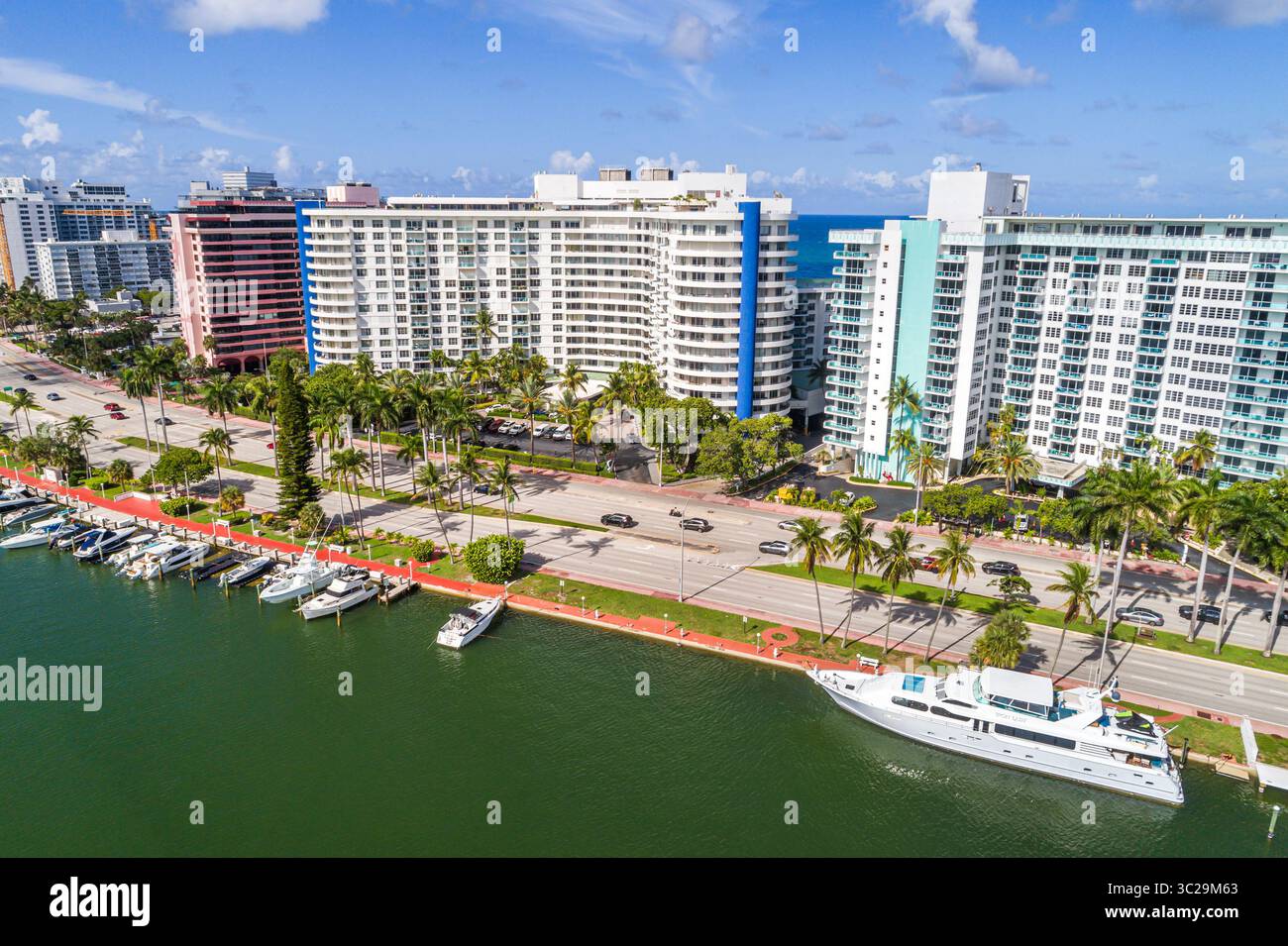 Resort style buildings with curved balconies and tropical trees hi-res ...