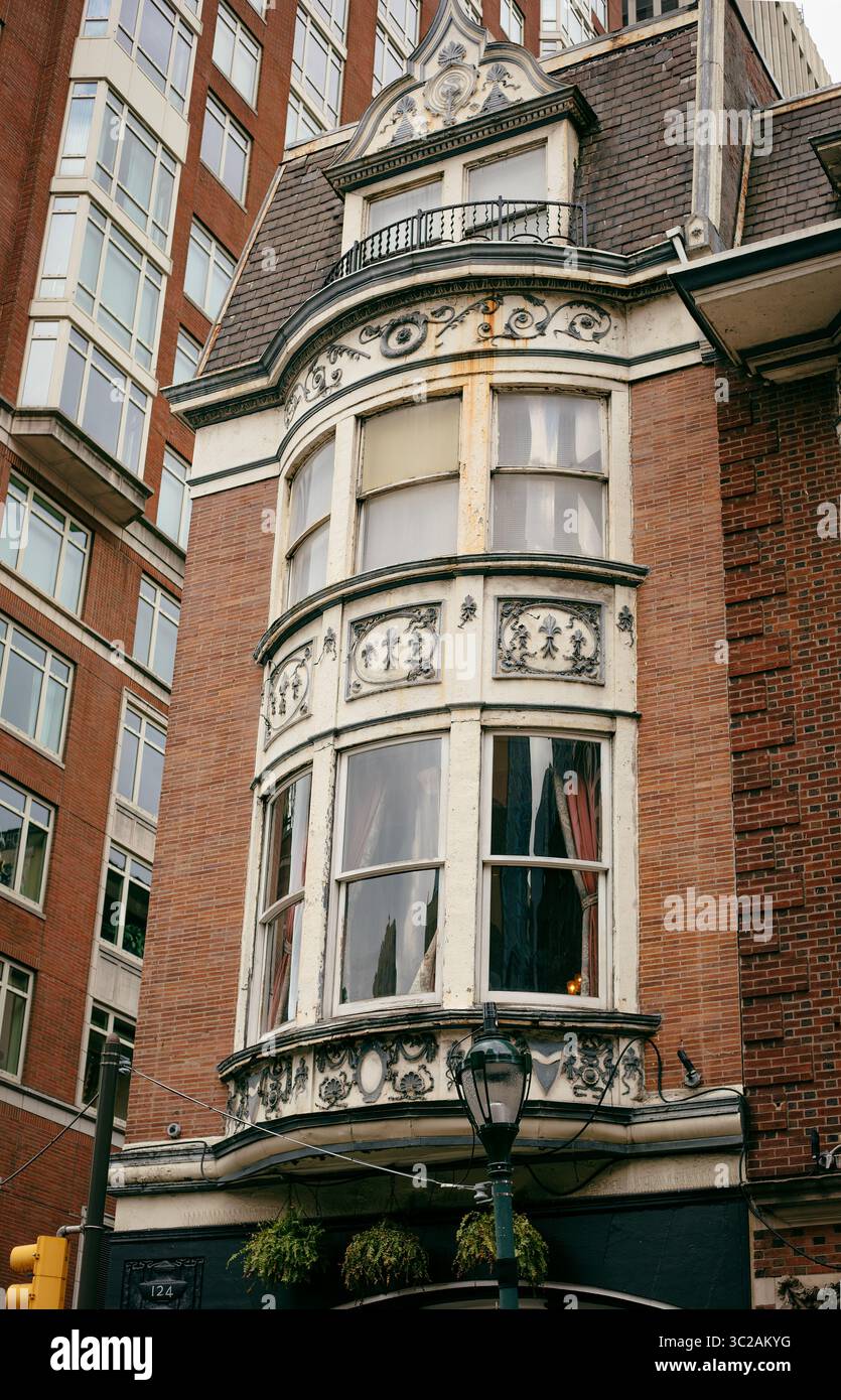 A historic city building with an ornate decorative facade, large bay ...