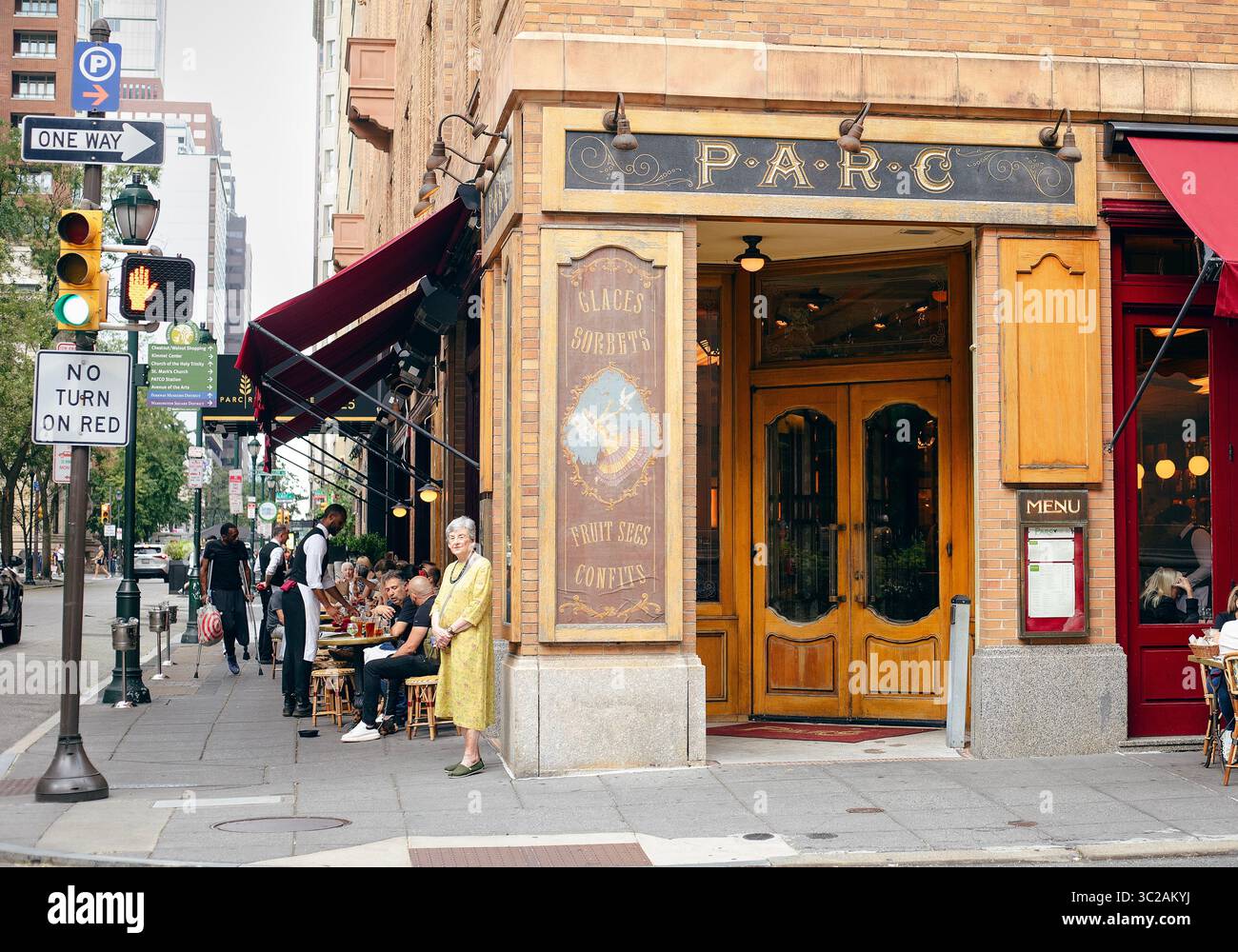 Historic facade of Parc restaurant with red awning and French doors ...