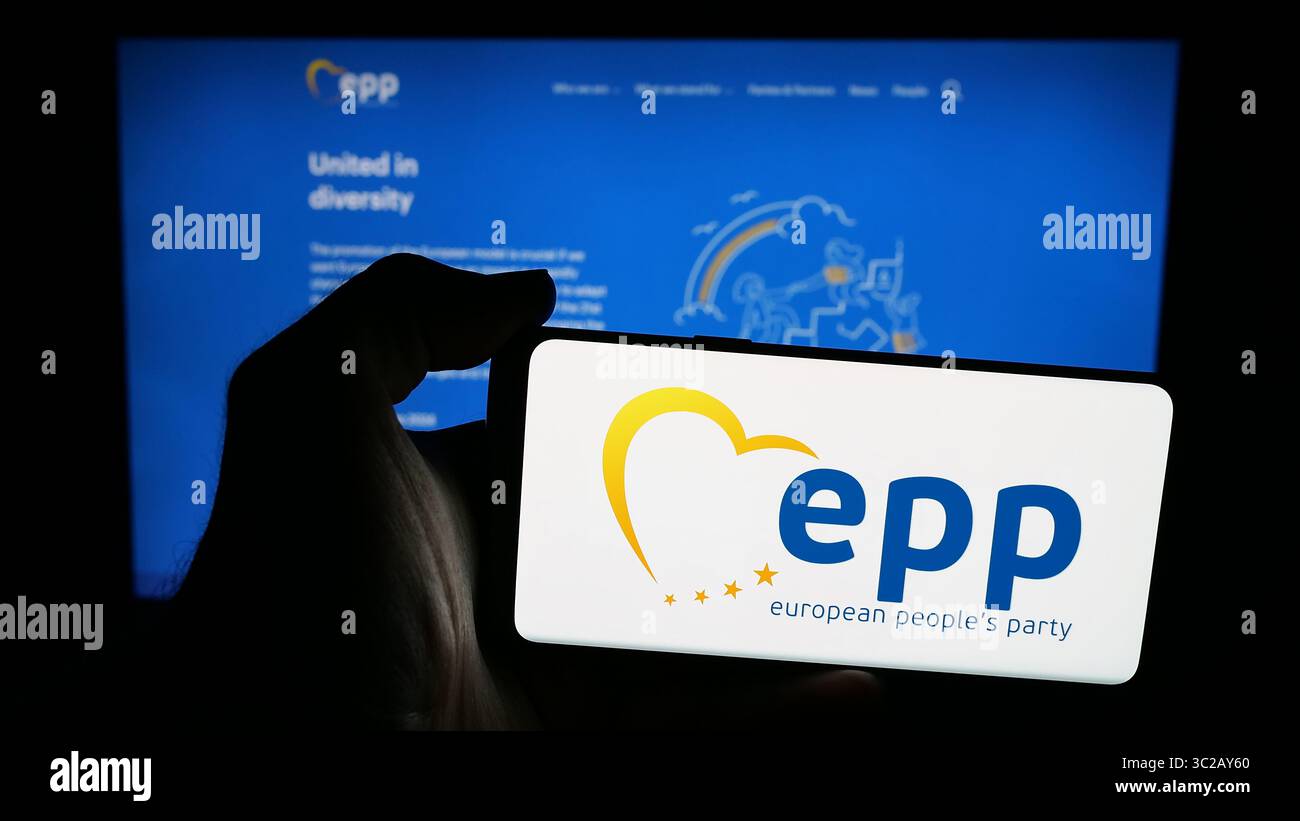 In this photo illustration, a person is holding a mobile phone with the ...