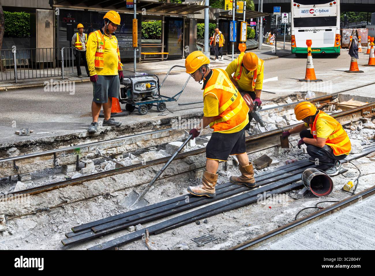 Construction workers repairing tram line keeping service running ...