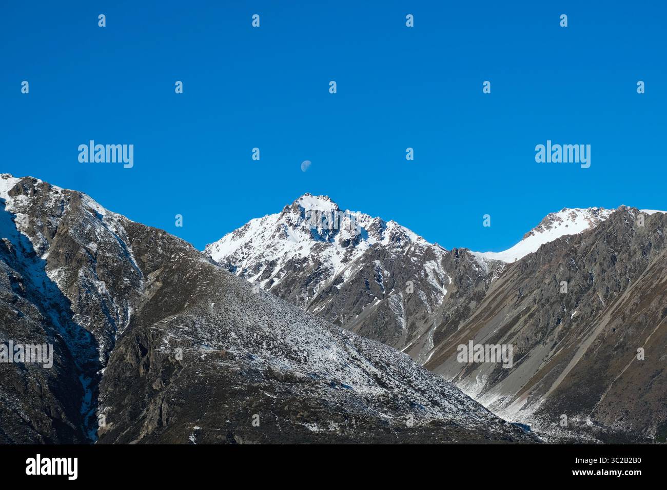 Snow capped peak with clear sky and moon in Aoraki, Mount Cook National ...