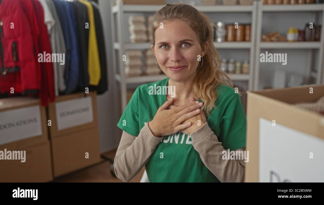 Woman clutching chest conveys gratitude in a spacious warehouse where a ...