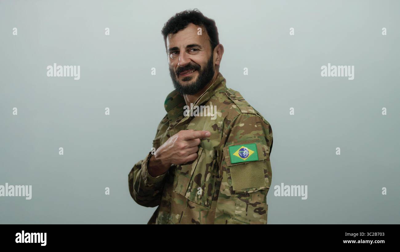 Hispanic man in military uniform points to brazilian flag patch on his ...