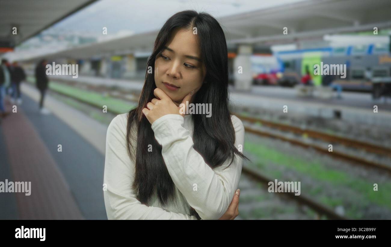Chinese woman in white shirt at busy train station outdoors ...