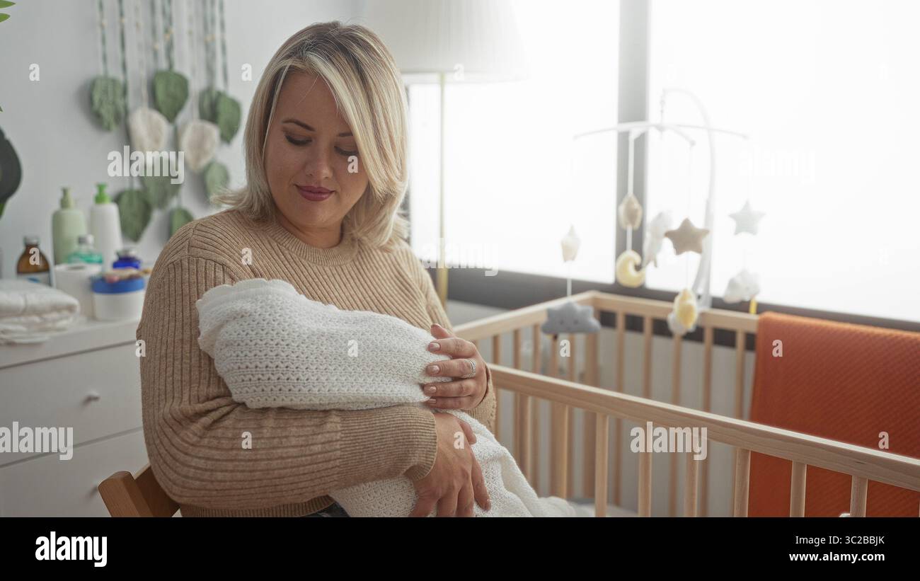 Young mother cradles sleeping baby hi-res stock photography and images ...