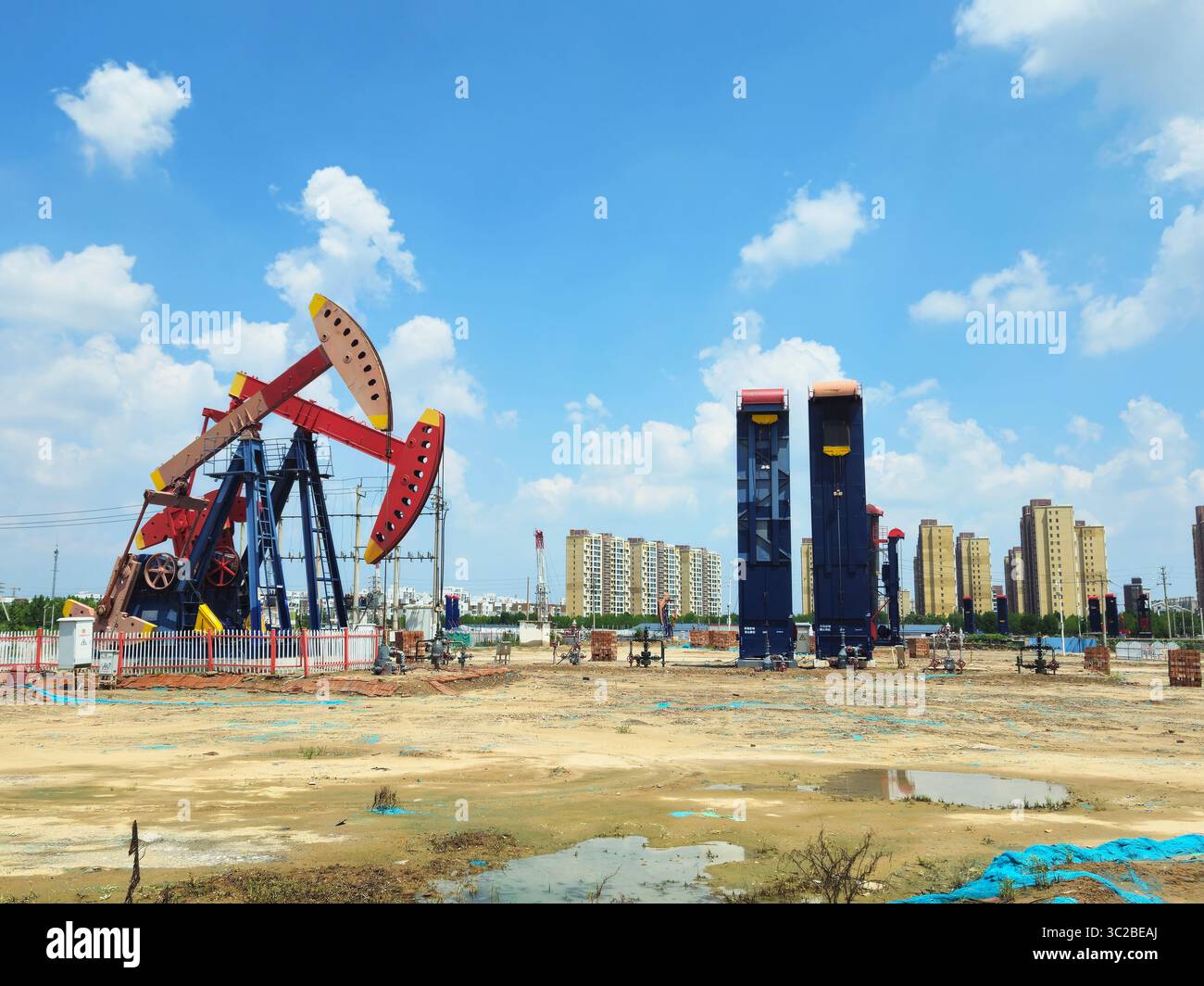 Oil Pumpjacks and Urban Skyline at Sinopec Shengli Oilfield, Dongying ...