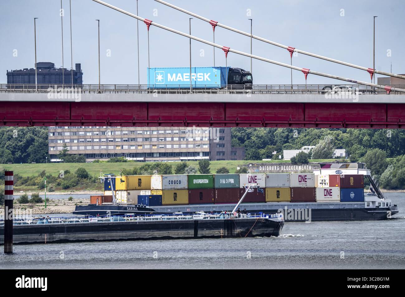 Barges on the Rhine at Ruhrort harbour, container freighter on uphill ...