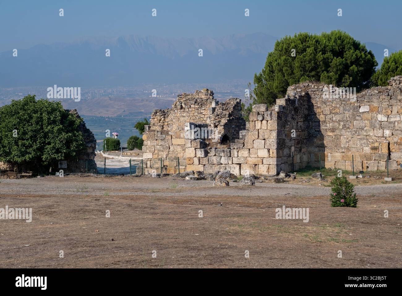 Discover the ancient ruins of Pamukkale surrounded by lush greenery and ...