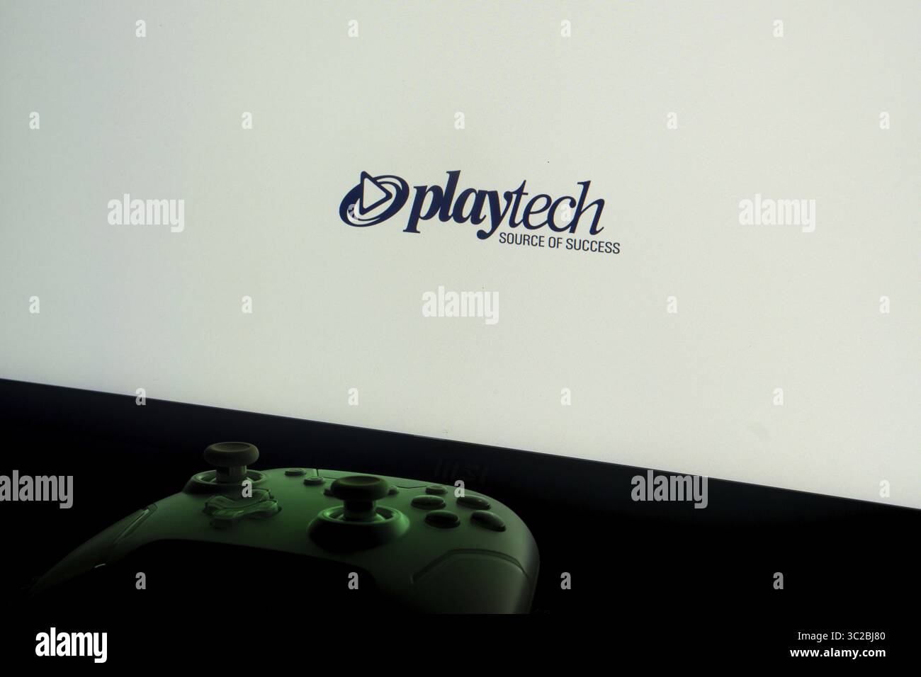 A screen displaying the Playtech logo above a gaming controller in low ...