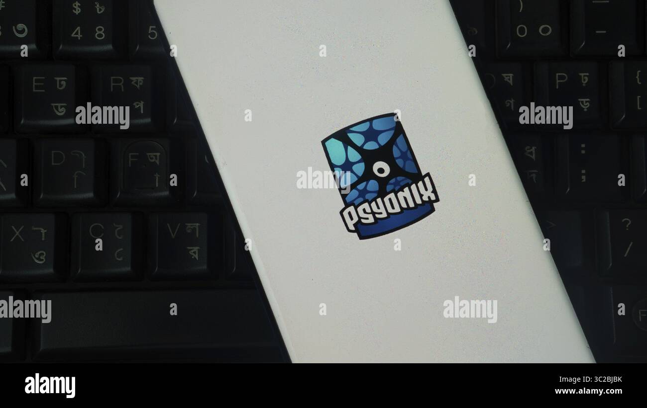 Smartphone on keyboard, showing Psyonix logo on a white screen Stock ...