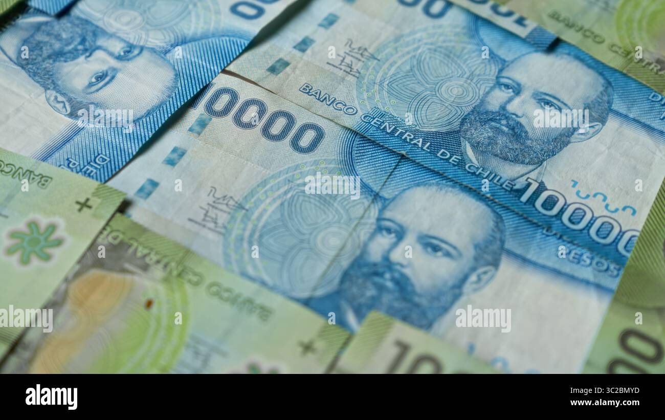 Closeup of chilean 10000 peso banknotes featuring a portrait with banco central de chile text ...