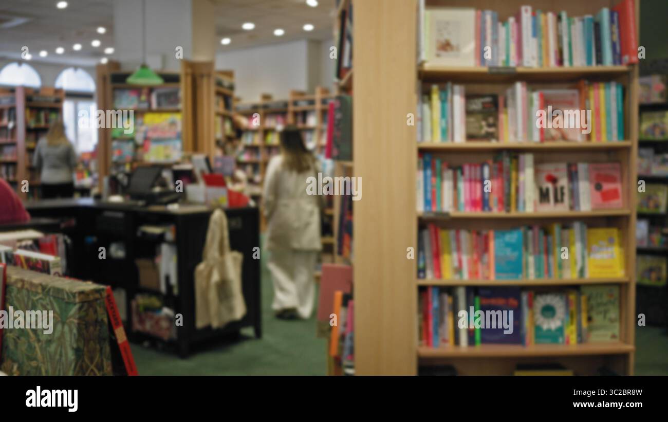 Blurred woman browsing books in a library environment with colorful ...