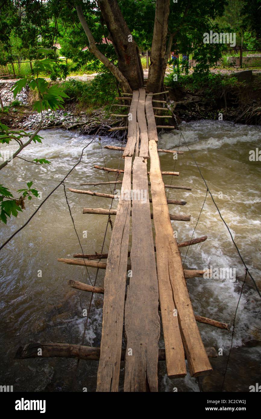 Handmade exotic bridge over a river Stock Photo - Alamy
