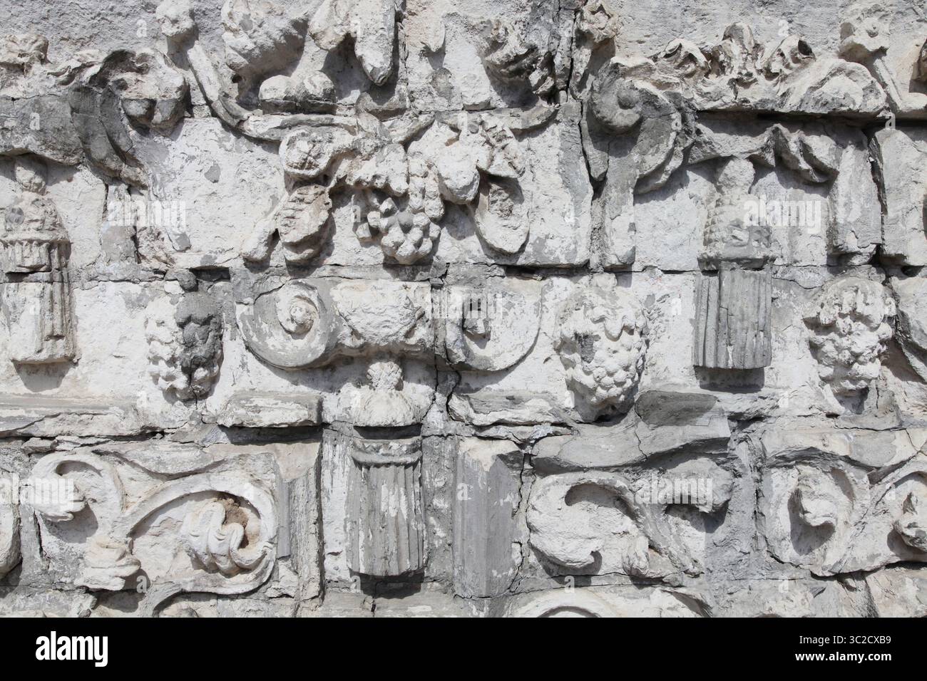 Detailed stone wall relief showcases intricate grapevine designs and ...