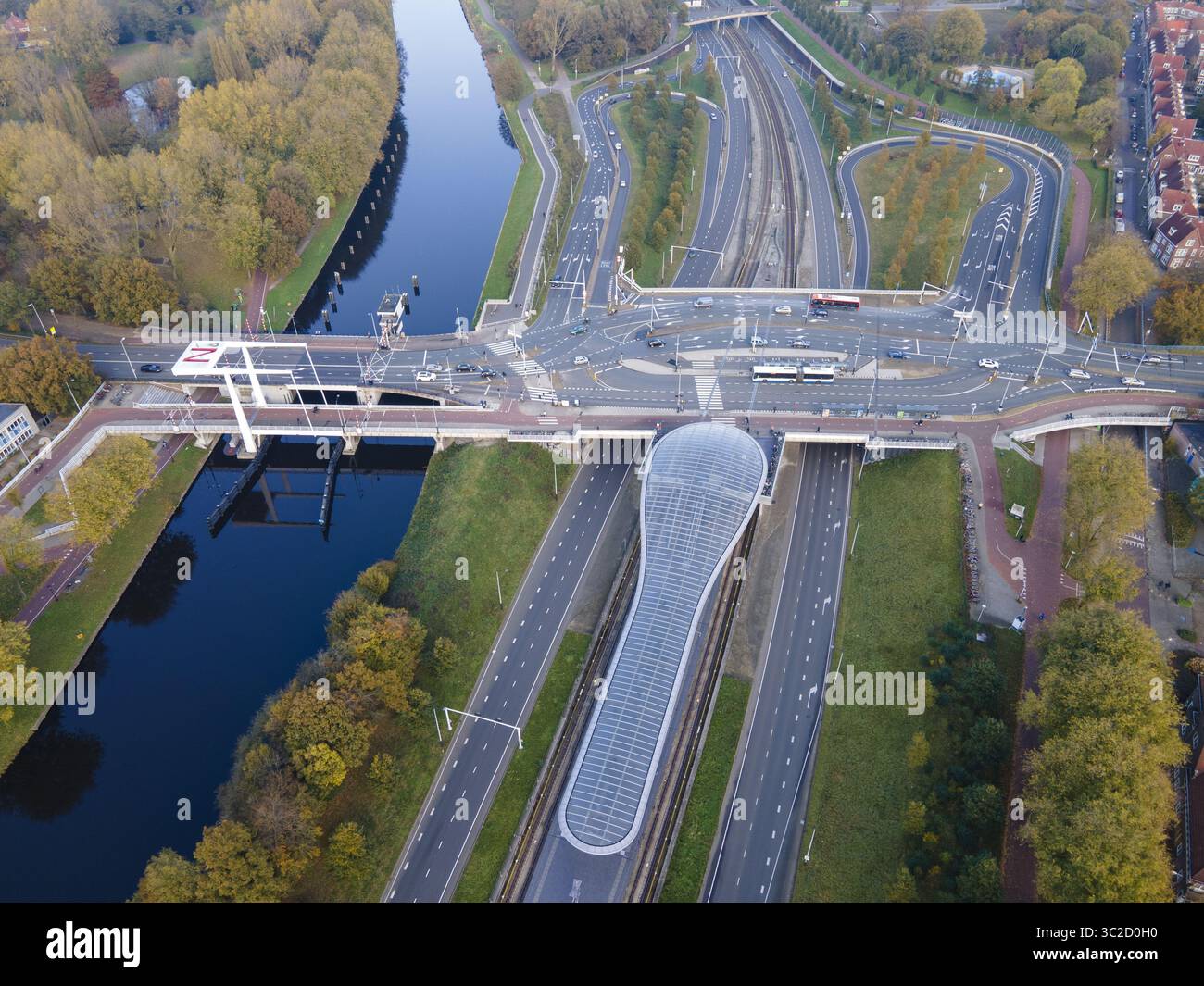Aerial view of a modern transport hub with flowing waterways and autumn ...