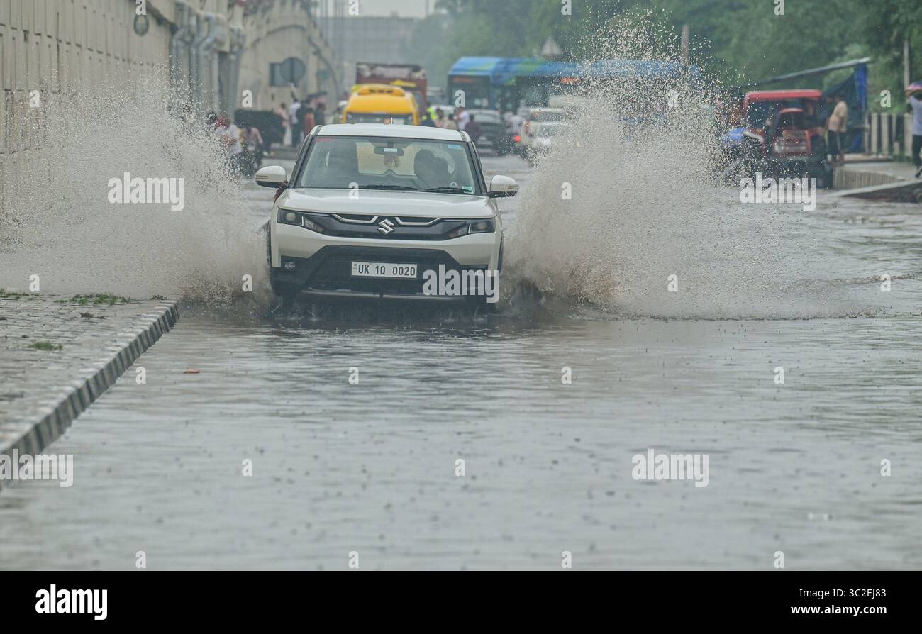 NEW DELHI, INDIA - JULY 23: Vehicles wade through waterlogged roads ...