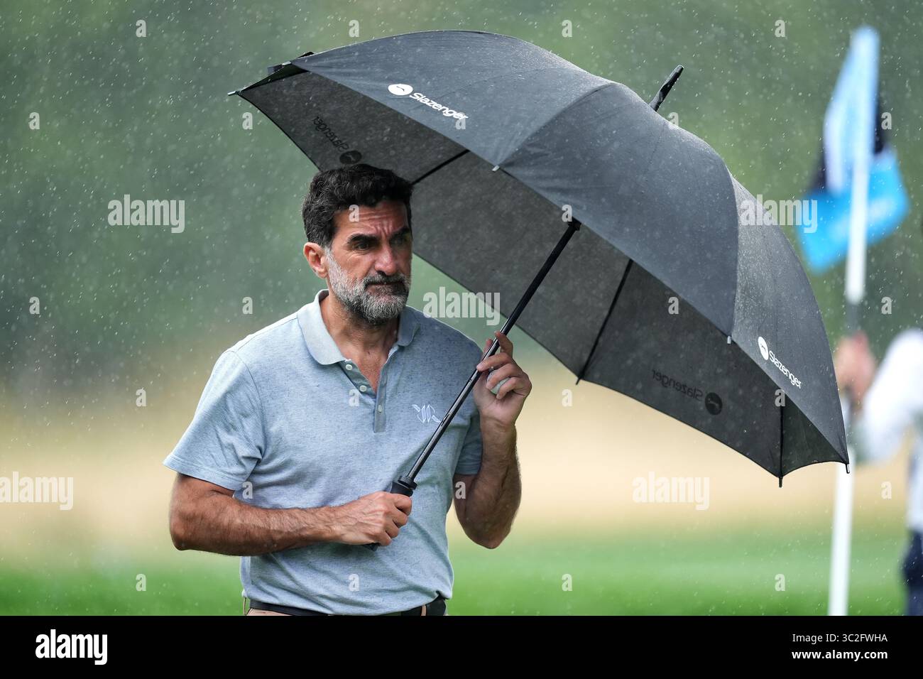 LIV Golf Chairman Yasir Al-Rumayyan holds an umbrella during the ...