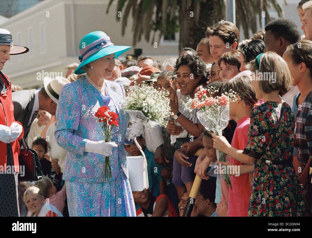 Members of the crowd reach out to touch Queen Elizabeth II during her ...