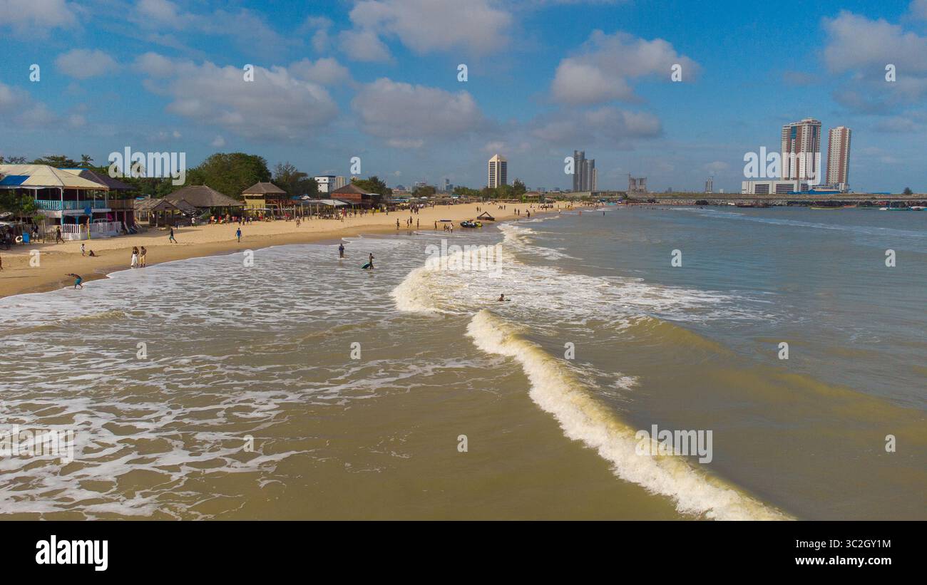 Aerial view of sun-kissed sands meet the rolling waves at a beach near ...