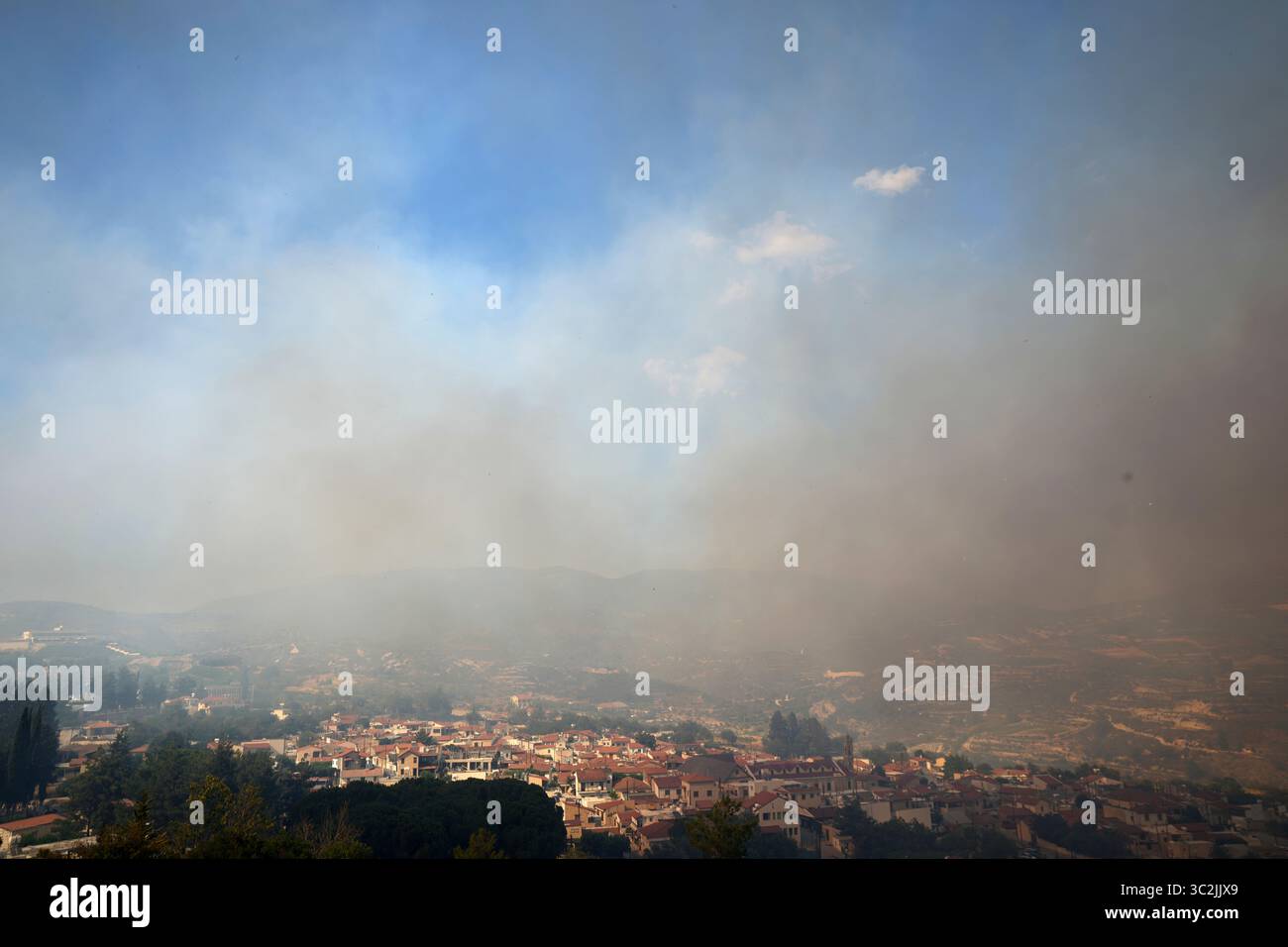 Smoke from a fire covers the sky over Omodos village, Cyprus, during a ...
