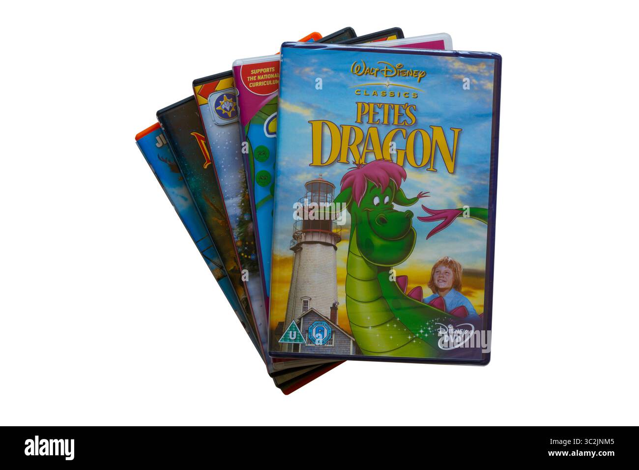 pile of DVDs with Walt Disney Classics Petes Dragon DVD on top isolated ...