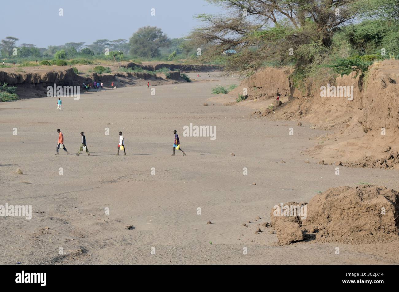 KENYA, Turkana, Kakuma, refugee camp, refugees carry water over long ...