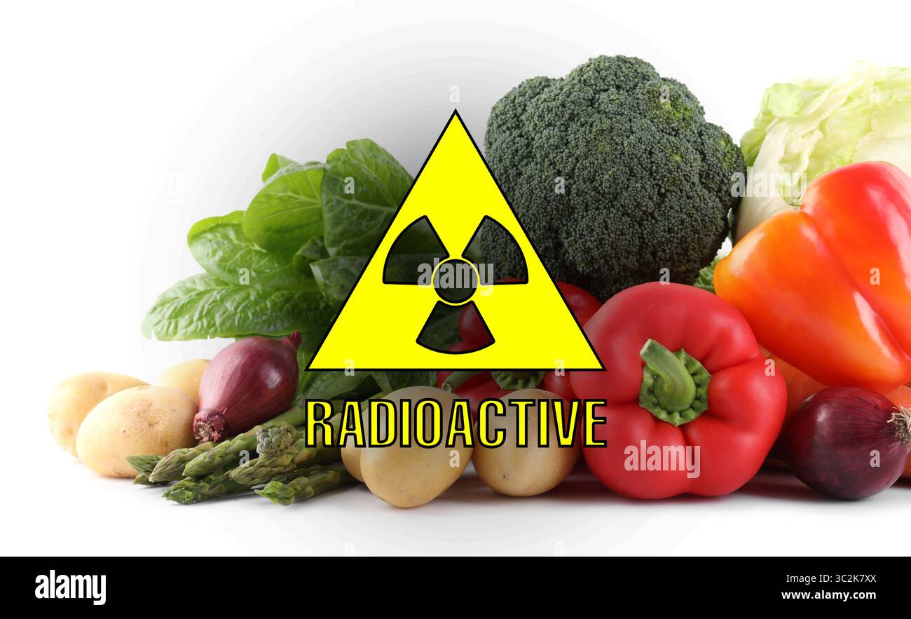 Fresh vegetables and radioactive sign on white background ...