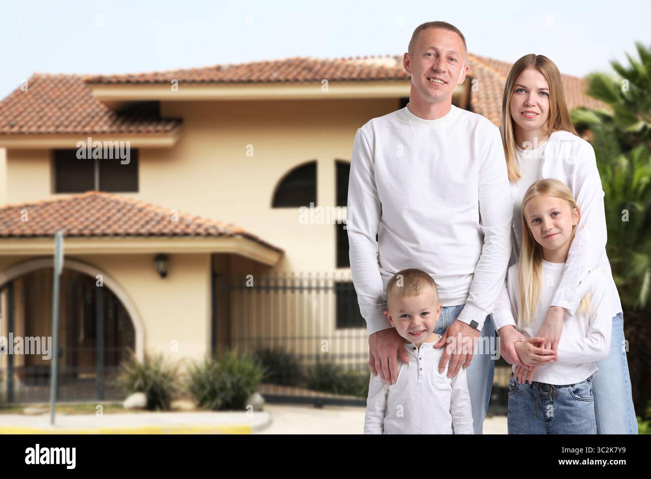 Family with two kids near their house outdoors Stock Photo - Alamy