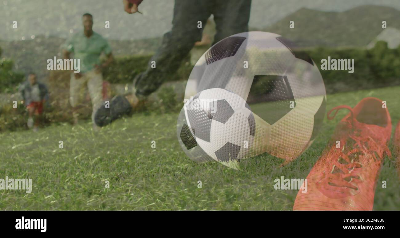 Kicking player wearing track pants sending soccer ball rolling across ...