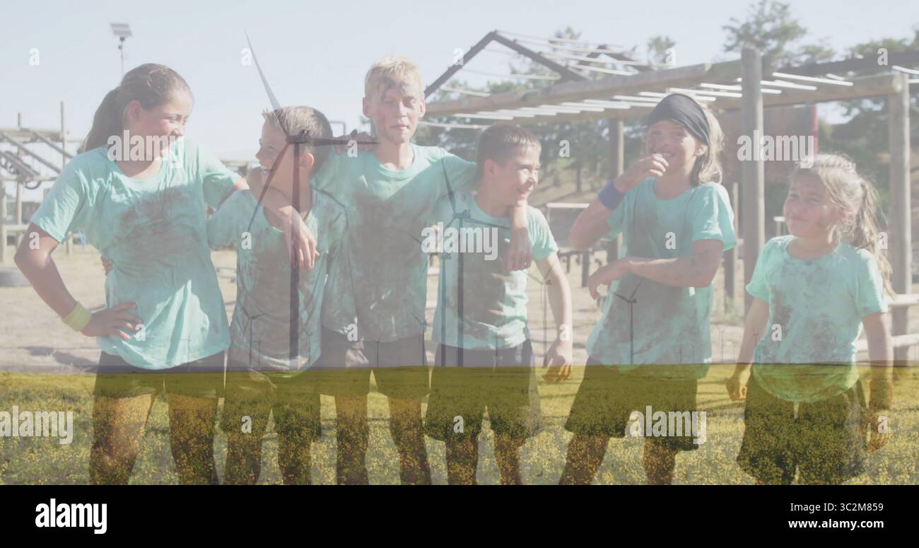 Standing six children wearing muddy blue uniforms on grassy field, with ...