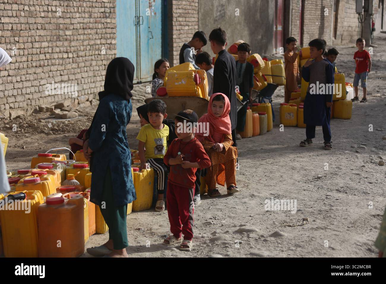 Kabul, Afghanistan. 22nd July, 2025. Children crowd around a communal ...