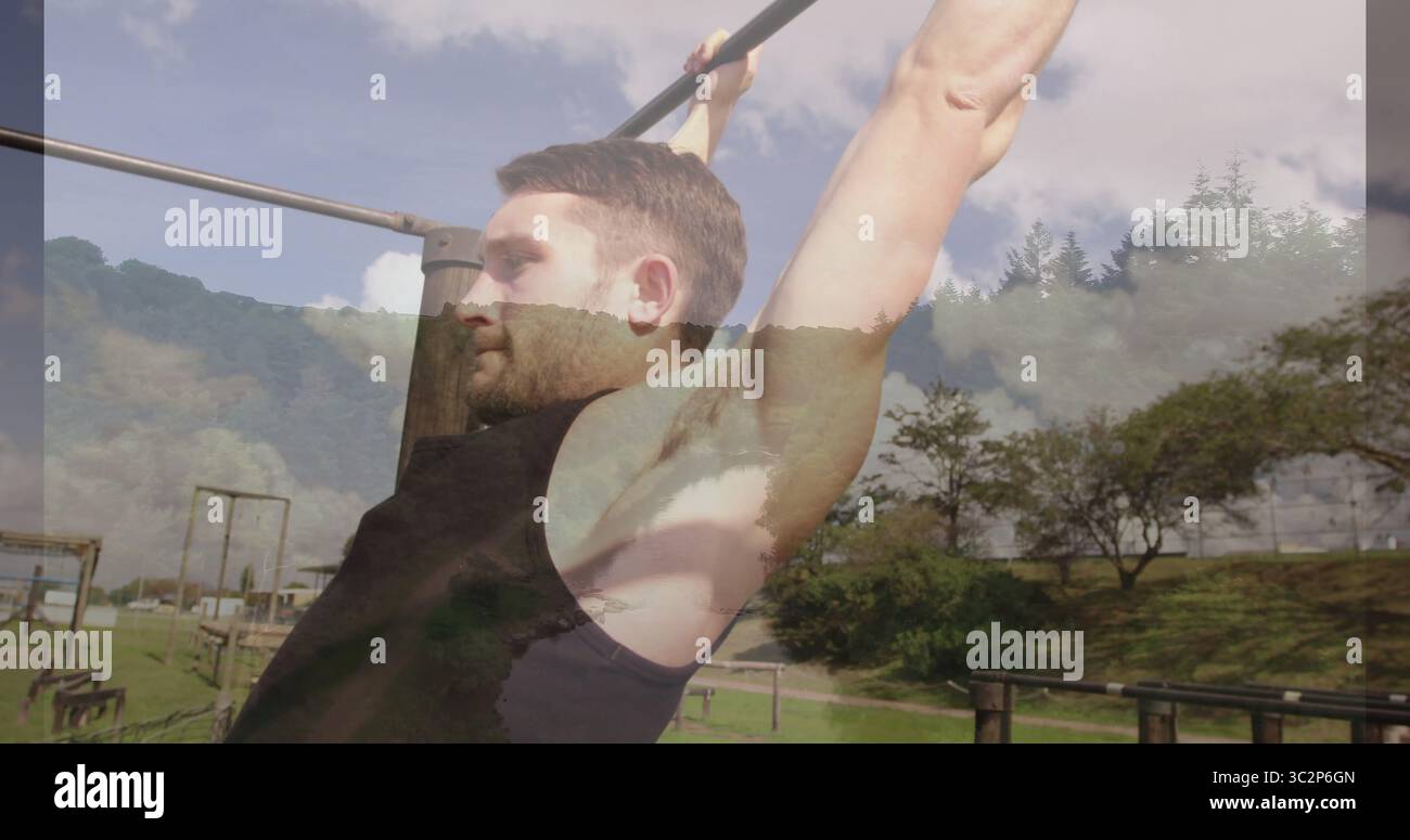 Hanging athletic man holding overhead pull-up bar at park exercise area ...