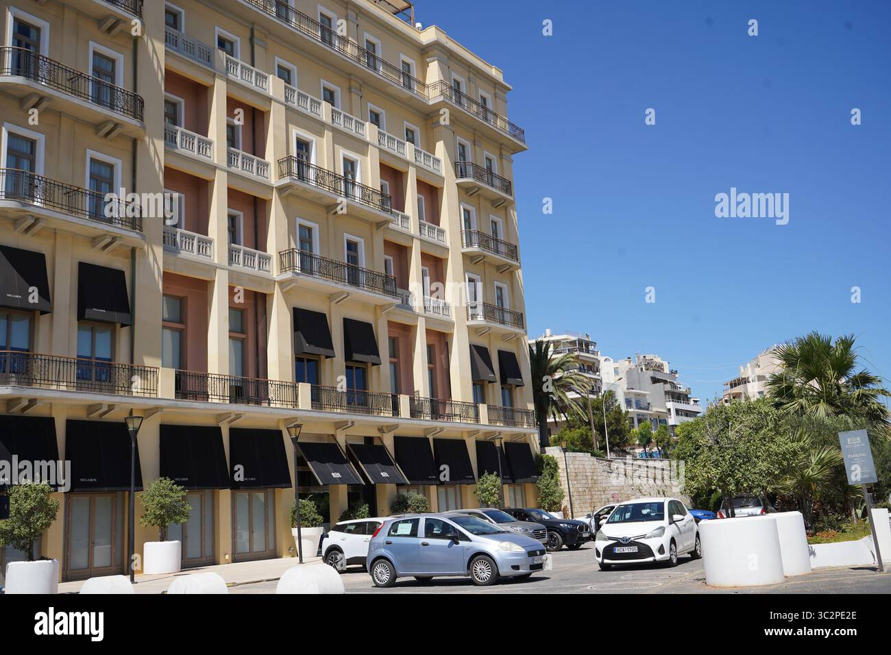 Megaron Hotel, a five-story building with a neoclassical facade ...