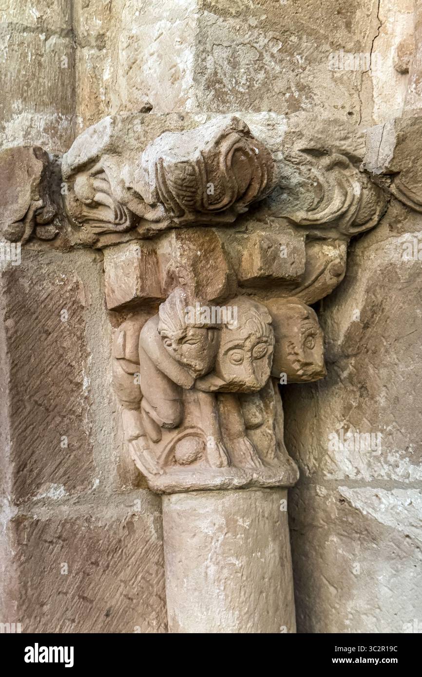 Close-up of intricate Romanesque capital with symbolic sculpted figures ...