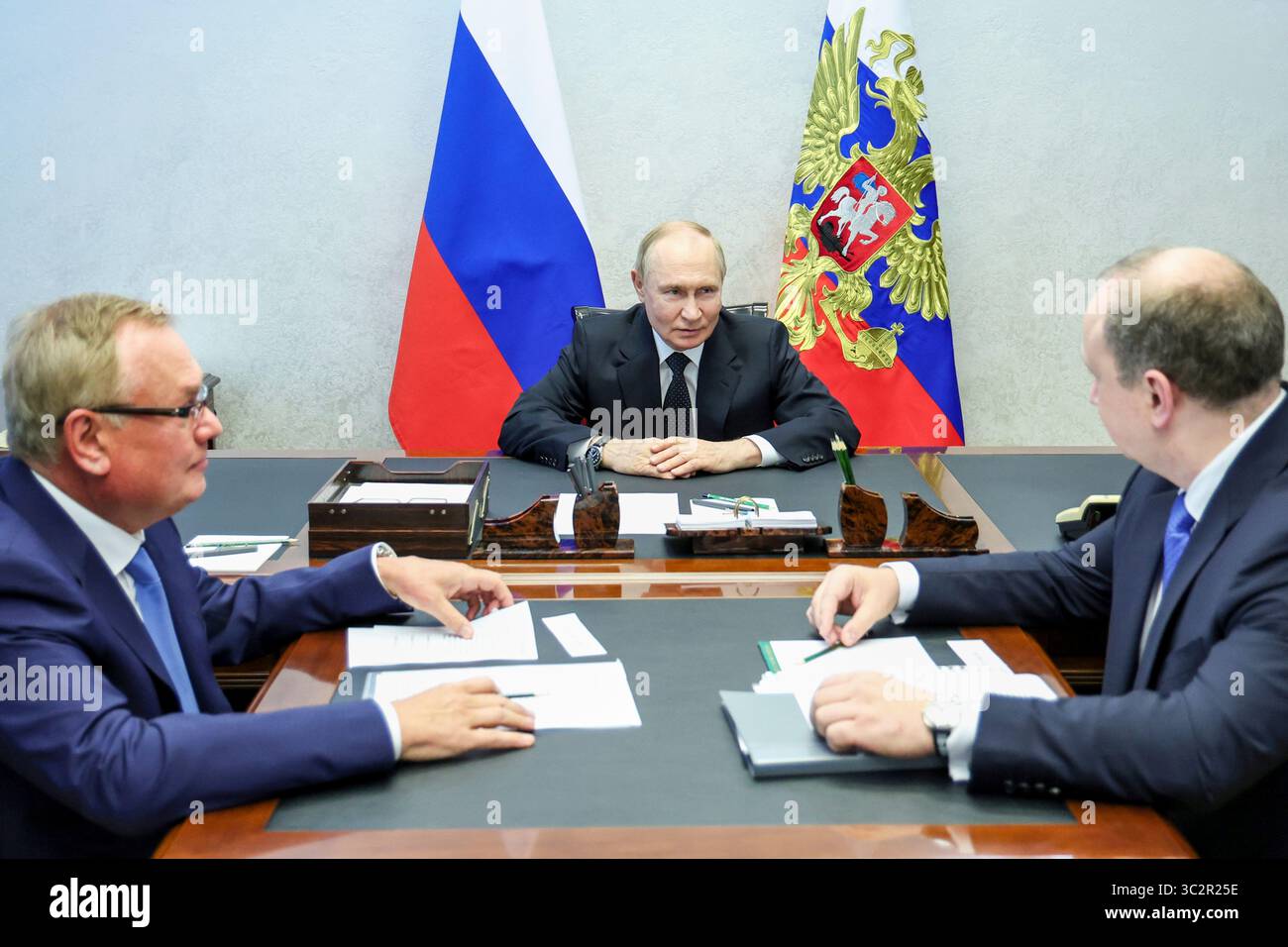 Russian President Vladimir Putin, center, speaks with VTB Bank Chairman ...
