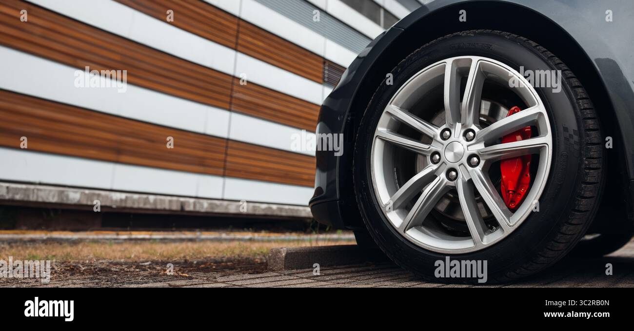 Front wheel of sport car. Rims and brake system on sport car coupe ...
