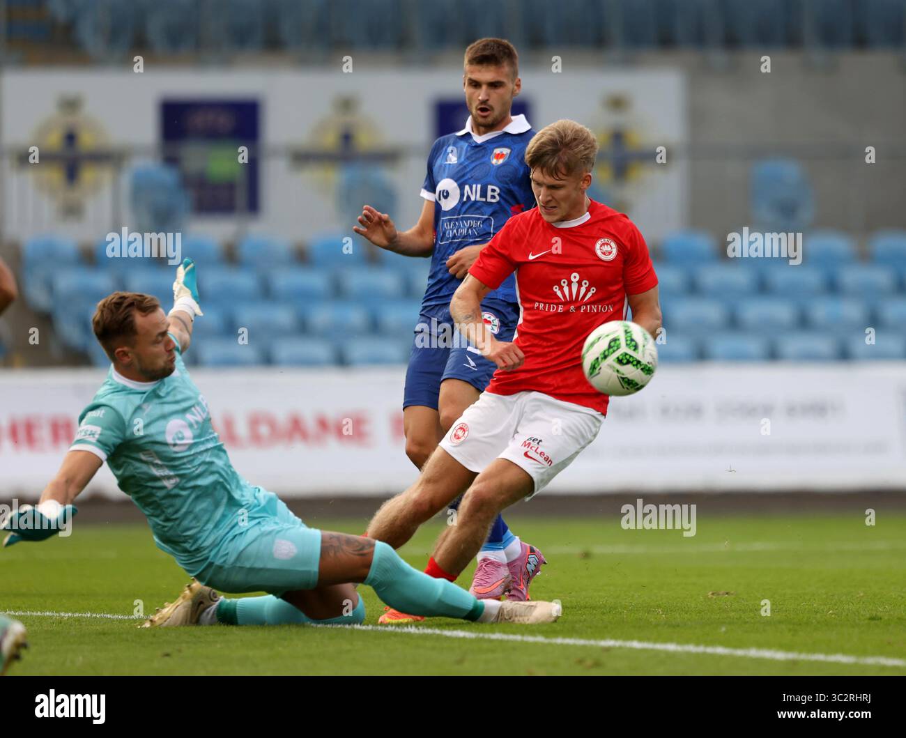 Prishtina goalkeeper Ardit Nika saves from Larne's Dylan Sloan during ...