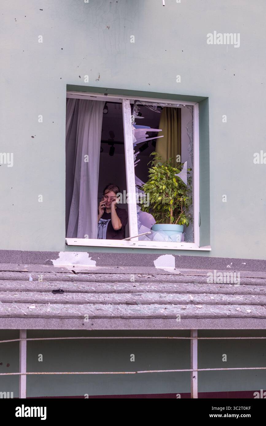 Civilians survey the damage after Russia attacked a residential area ...