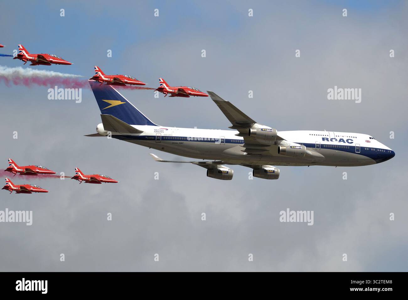 Boeing 747-400 of British Airways in old BOAC livery, in formation with the RAF Red Arrows at ...