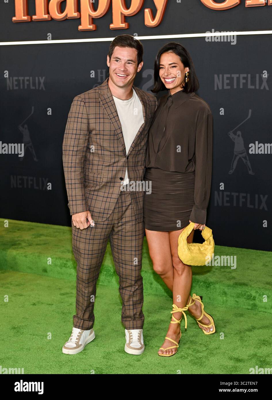 Adam Devine, left, and wife Chloe Bridges attend the premiere of ...